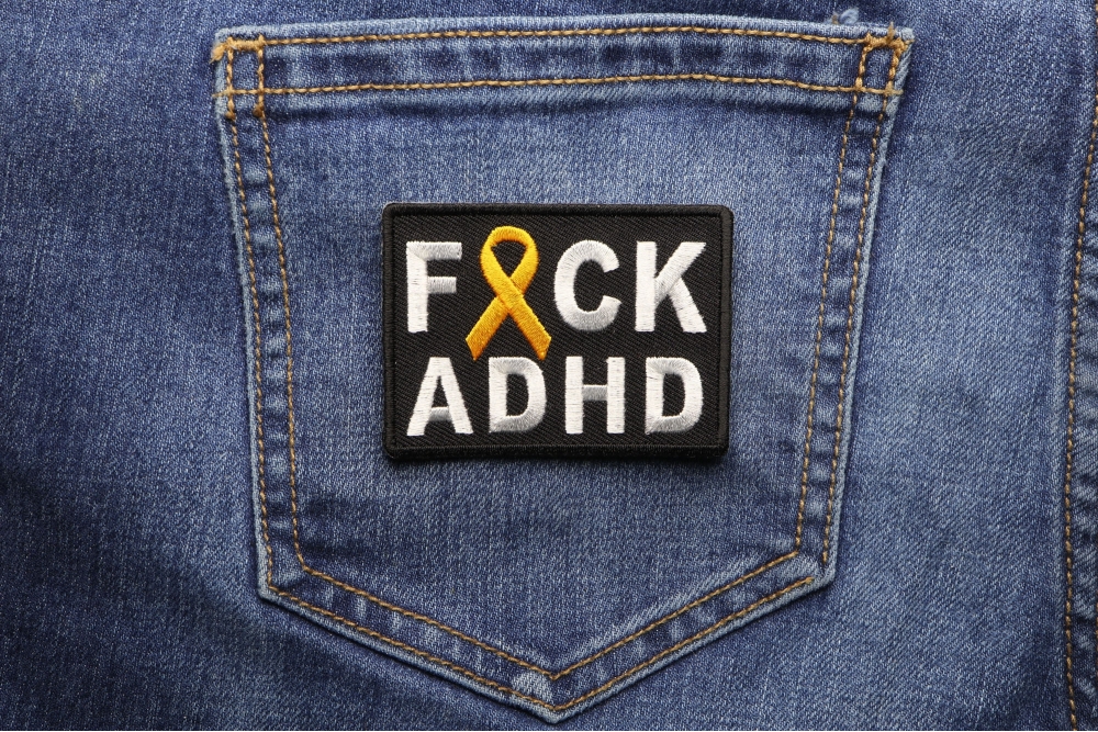 FCK ADHD Orange Ribbon Patch shown on jeans