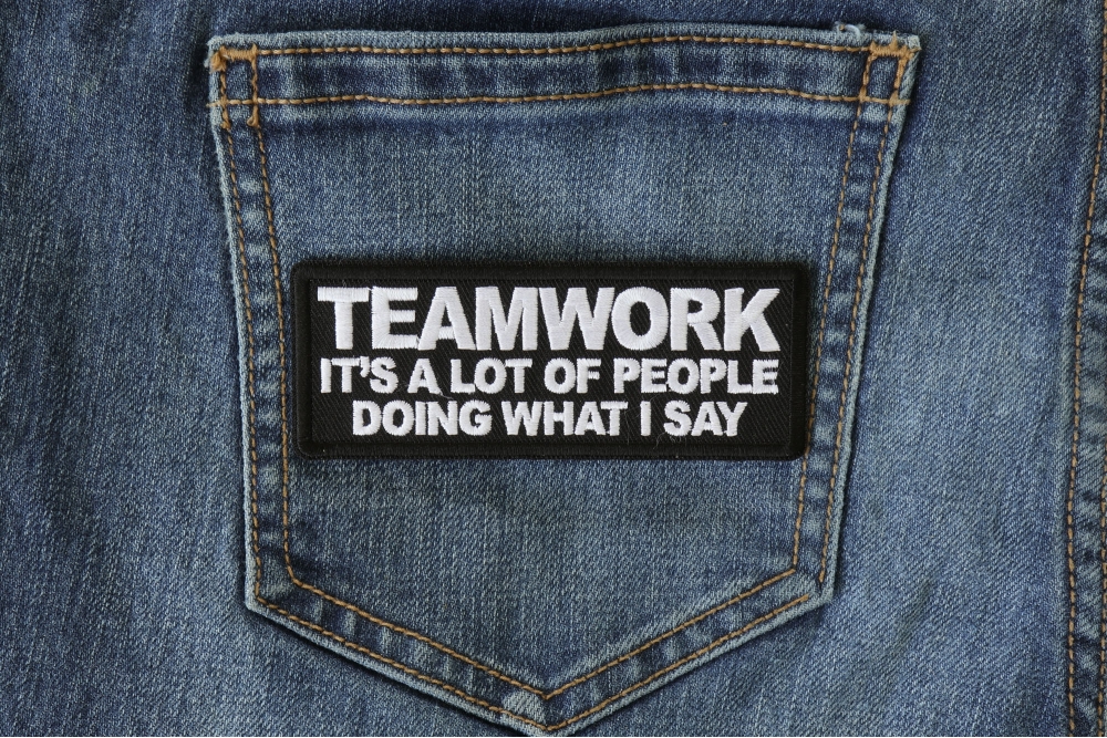 Teamwork It's a lot of People doing What I Say Funny Iron on Patch shown on jeans