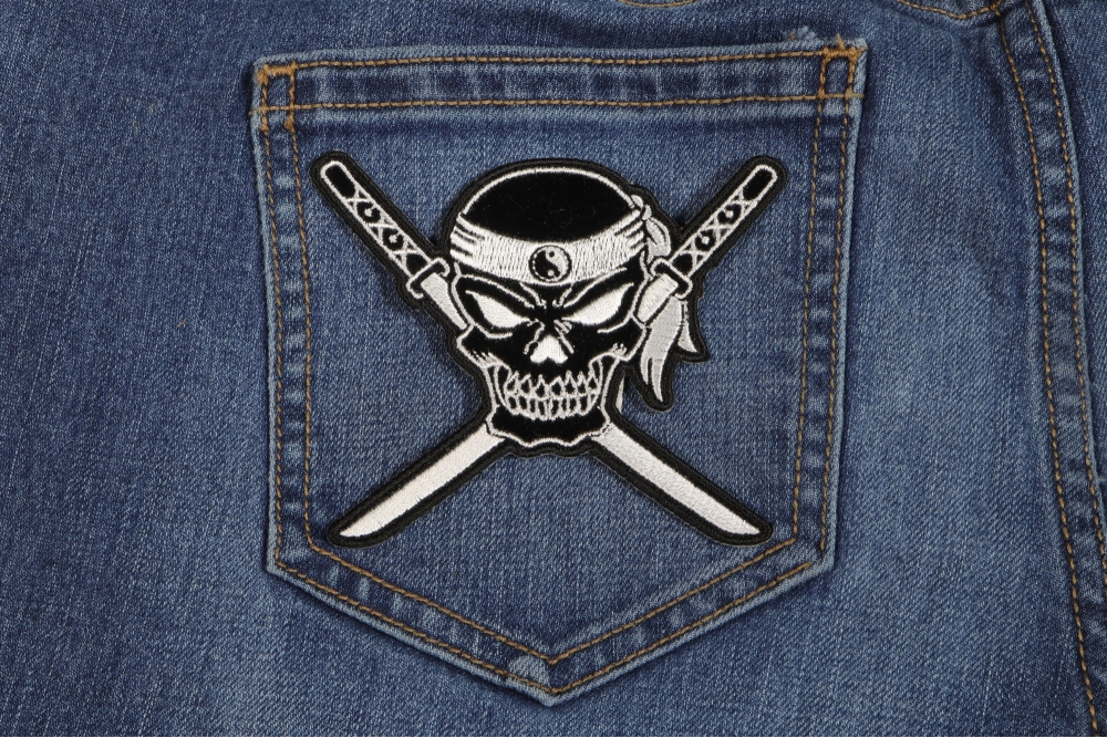 Small Skull Cross Swords Patch shown on jeans