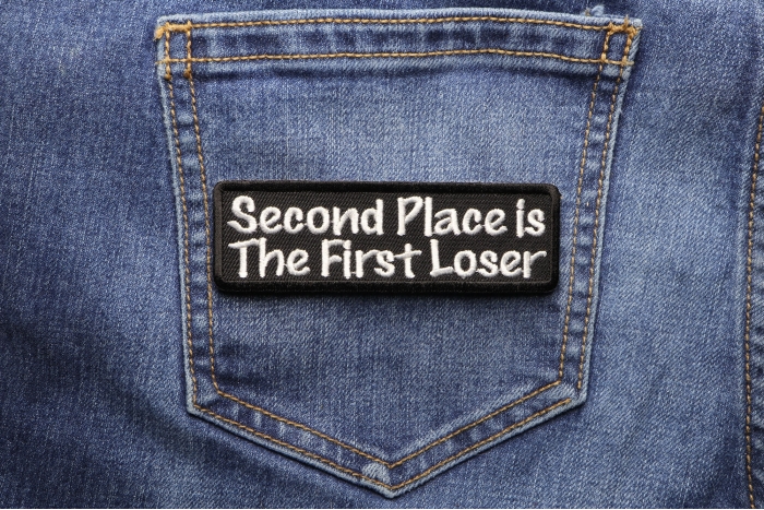 Second Place Is The First Loser Patch shown on jeans